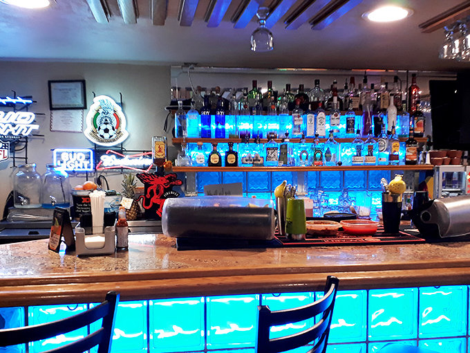 The bar's blue illumination transforms ordinary bottles into an underwater treasure display—making even tequila selection feel like a deep-sea adventure.