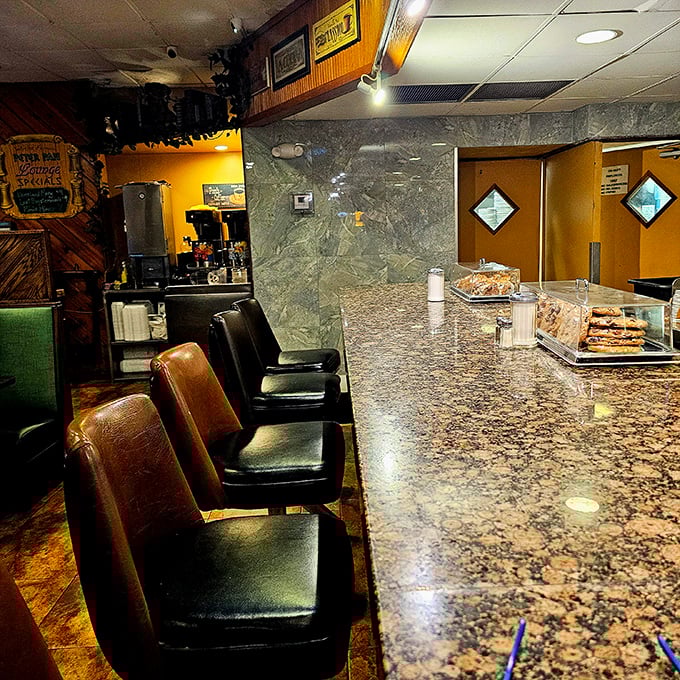 The counter seating—where solo diners become temporary neighbors and the marble-topped bar has witnessed more coffee refills than a barista's wildest dreams.