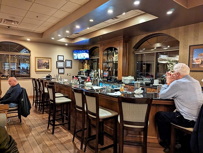 The bar at Joe's – where strangers become friends and regulars are treated like royalty. Polished wood and good conversation flow freely.