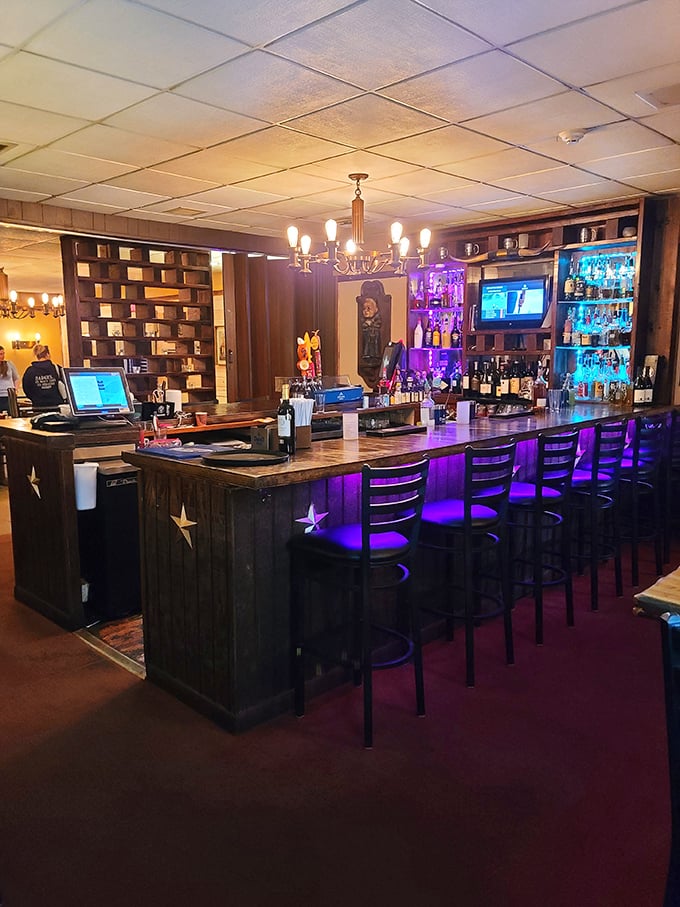 The bar isn't just where drinks are served—it's command central for evening enjoyment. Those purple lights set the mood for stories that get better with each round.