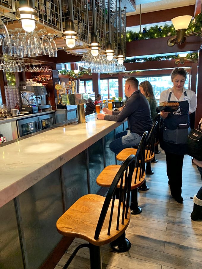 The bar isn't just where drinks are made—it's where stories are shared. Nautical-inspired lighting creates the perfect backdrop for seafood tales.