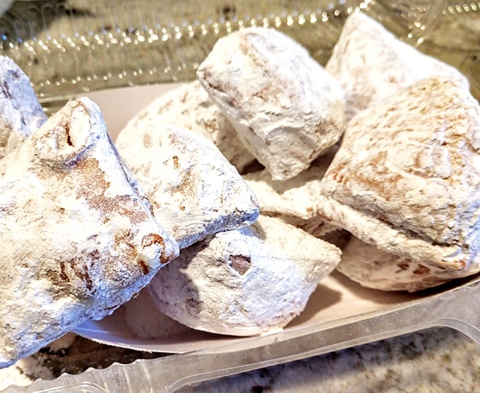 Powdered sugar pillows that collapse with a puff when bitten – leaving evidence on your shirt and joy in your soul.