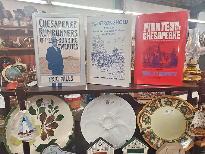 Local history bound in hardcover sits alongside decorative plates. Virginia's colorful past—from Prohibition rum-runners to Chesapeake pirates—preserved for curious minds.