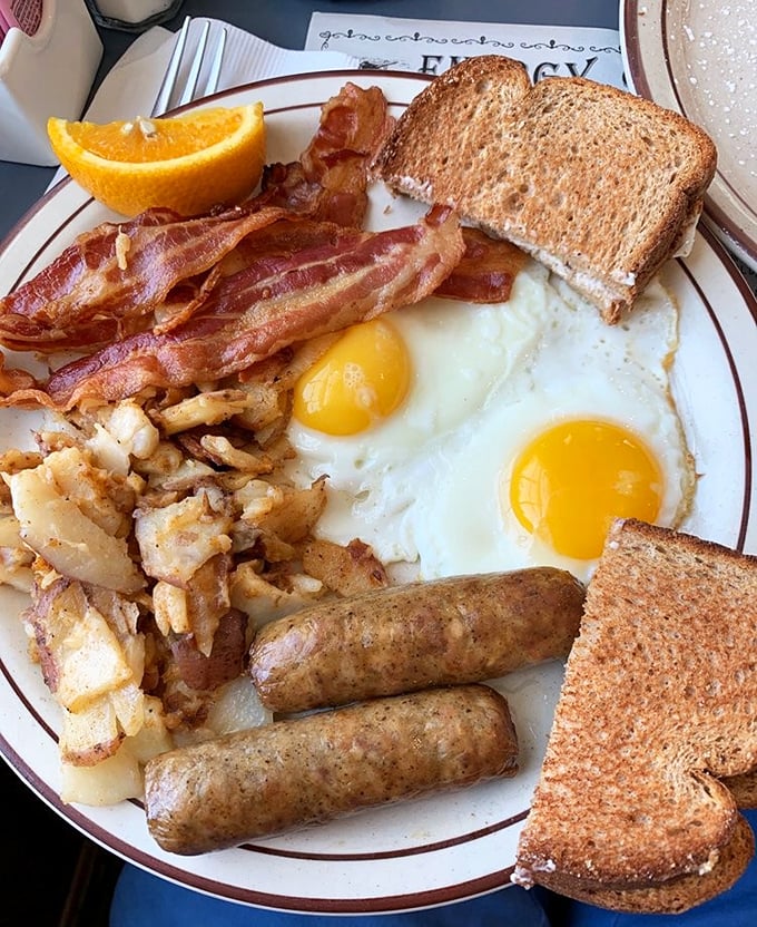 The breakfast plate that launched a thousand road trips—eggs, bacon, sausage, toast, and those legendary home fries worth crossing state lines for.