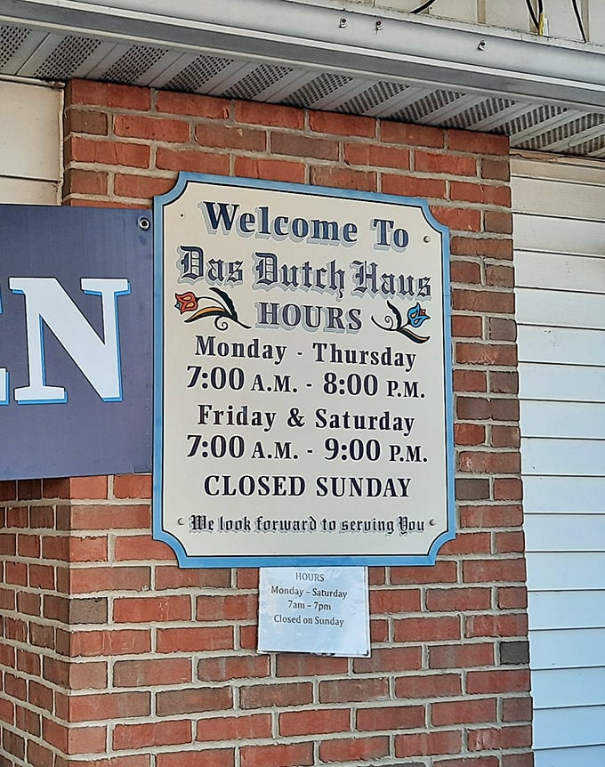 Business hours posted with old-world charm—the kind of sign that politely says "plan accordingly" while looking absolutely delightful.