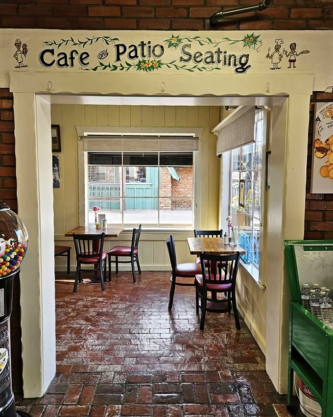 The cafe patio sign promises outdoor seating with a side of charm – because pastries always taste better with a gentle California breeze.