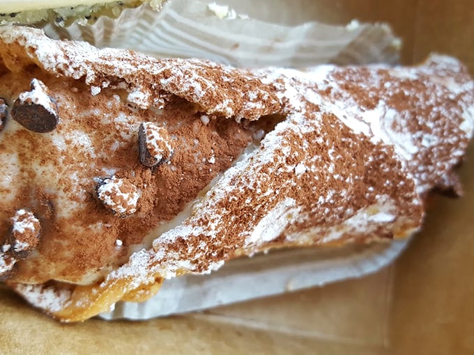Cannoli that would make any Italian grandmother nod in approval—crisp shells dusted with the promise of sweetness within.