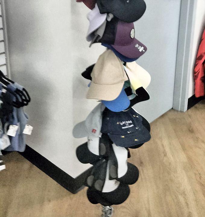 This cap collection could solve bad hair days for an entire Oklahoma county—stacked like a fashionable game of Jenga.