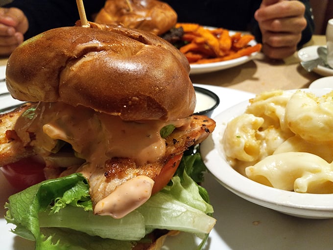 This isn't just a sandwich—it's an architectural marvel of chicken, sauce, and fresh vegetables that requires both hands and several napkins.