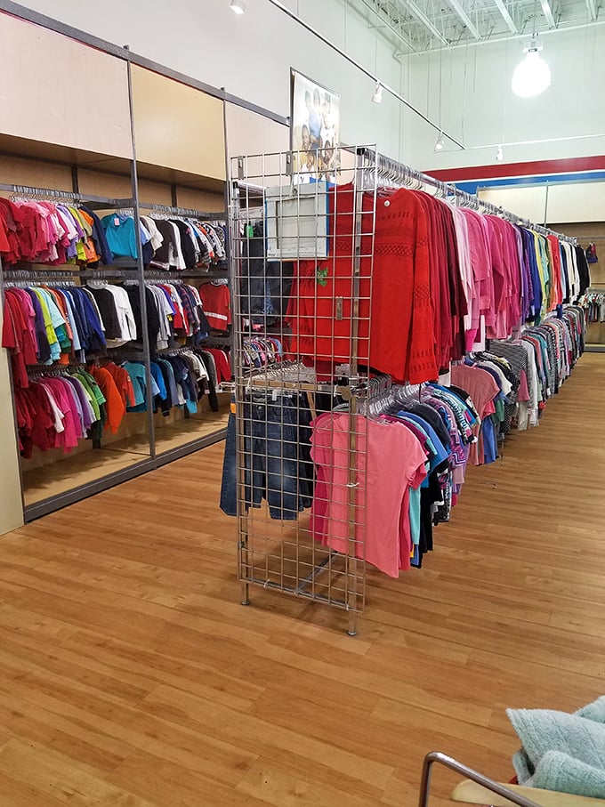 The rainbow road of retail therapy – color-coded clothing racks make finding your perfect hue a breeze.
