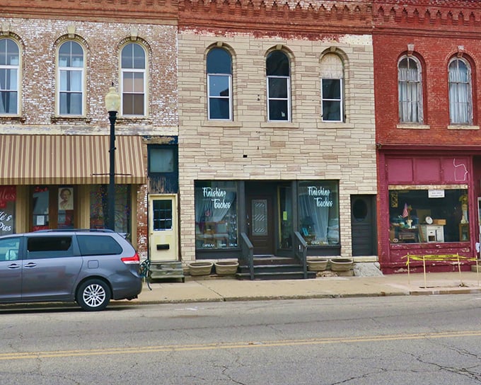 These storefronts in cream, brick, and burgundy showcase the architectural equivalent of a well-coordinated outfit – different but harmonious.