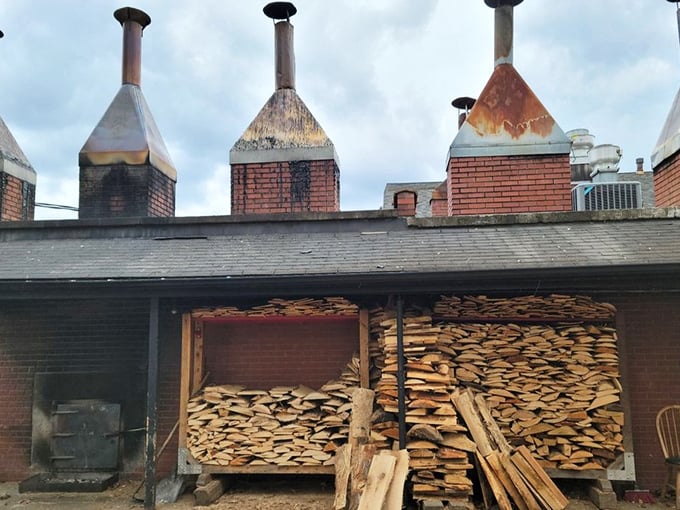 The smoke stacks and woodpile—barbecue's engine room. This is where the magic begins, with hickory logs transforming into flavor that defies explanation.