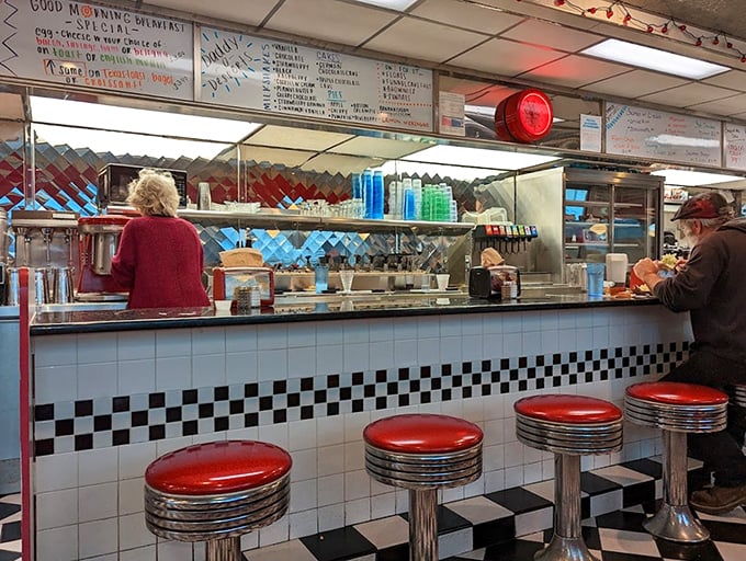 The counter – where solo diners become regulars and the coffee keeps flowing. Those red stools have heard every story Fairmont has to offer.