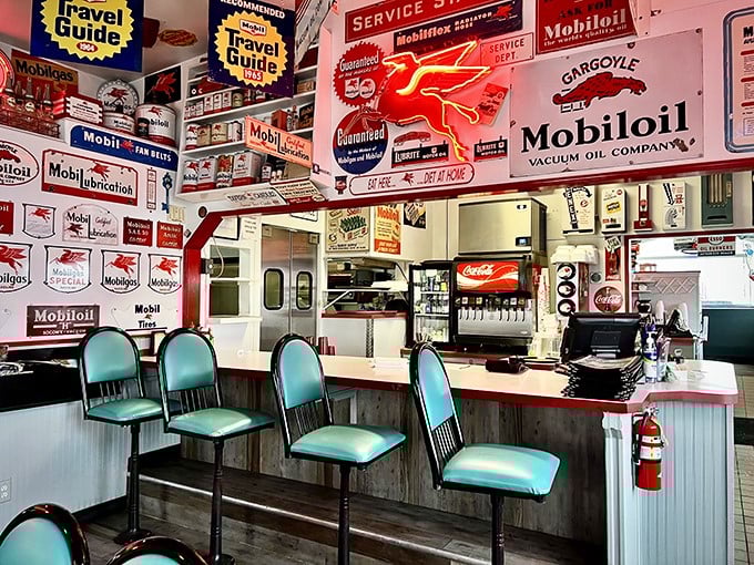 The counter where dreams and Mobil memorabilia meet. Those turquoise seats have witnessed countless coffee refills and life stories.