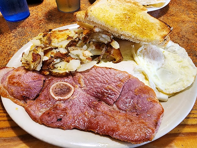 Country ham that's been cured longer than some marriages last, paired with eggs that remind you why breakfast is the superior meal.