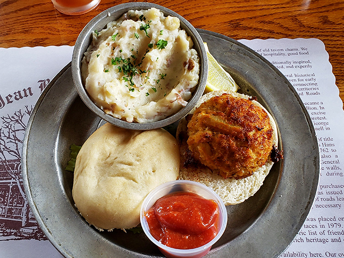 A crab cake sandwich that doesn't skimp on the star ingredient, paired with mashed potatoes that could make a Frenchman question his loyalty to pommes purée.