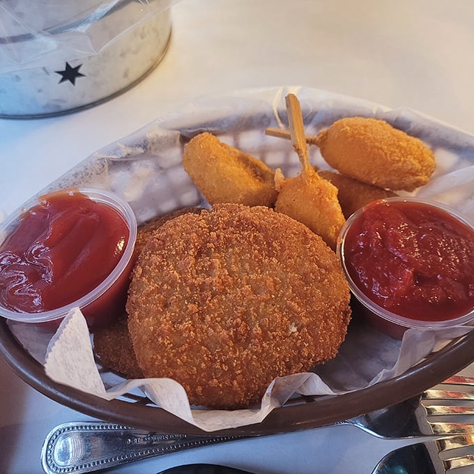 A crab cake surrounded by dipping sauces—the seafood equivalent of a celebrity with an entourage, and every bit as impressive.