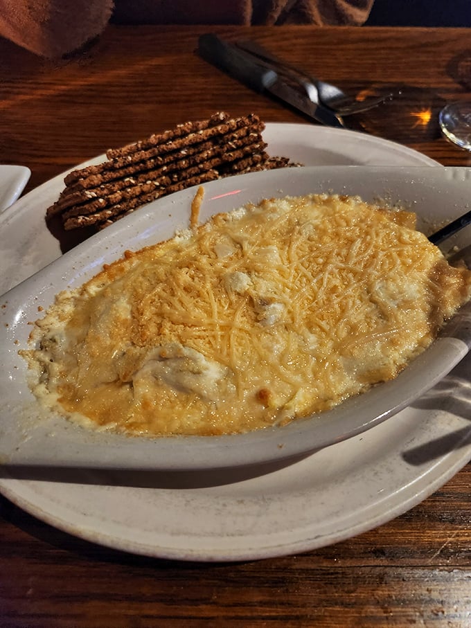 Bubbling hot crab dip with pretzel sticks standing at attention—a shareable treasure that rarely makes it to the second round of conversation.