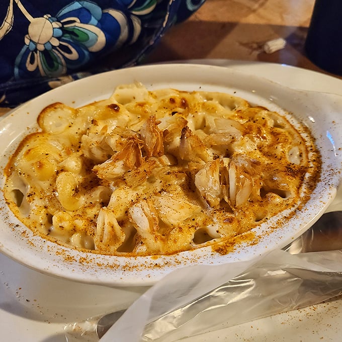 Crab mac and cheese that doesn't just combine two comfort foods—it elevates them into something transcendent, with visible lumps of crab throughout.