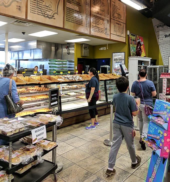 The bakery counter – where dreams are fulfilled, diet resolutions are forgotten, and the phrase "I'll just take one" becomes a laughable fiction.