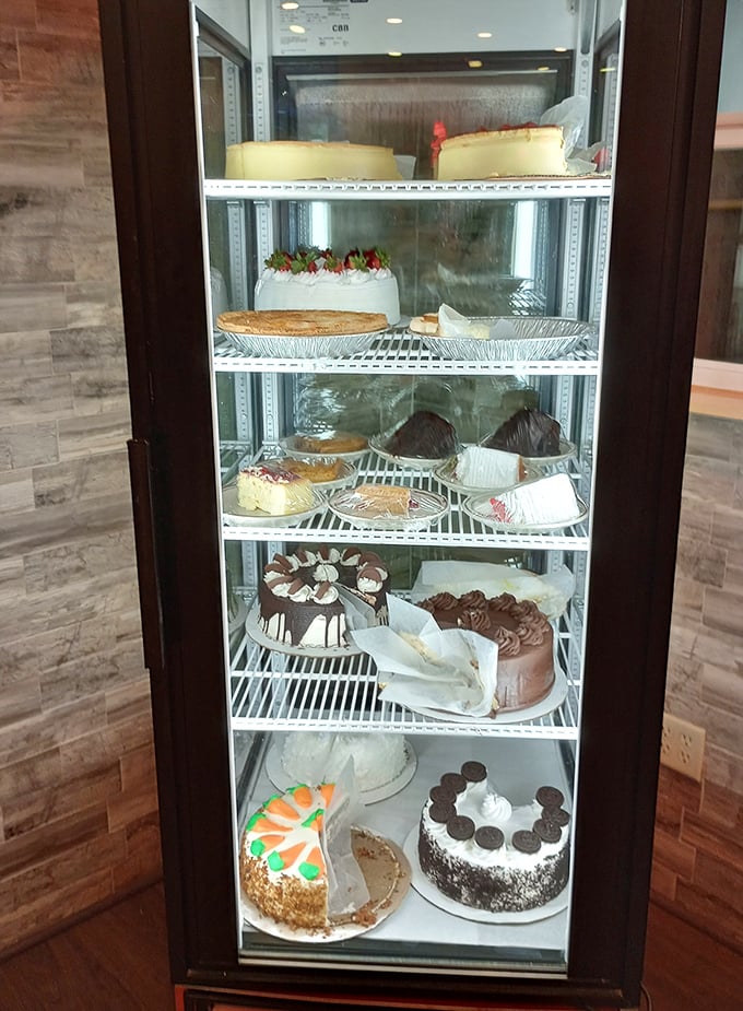The dessert case—where willpower goes to die a glorious, sweet death. Each shelf a different chapter in the story of "I shouldn't, but I will."
