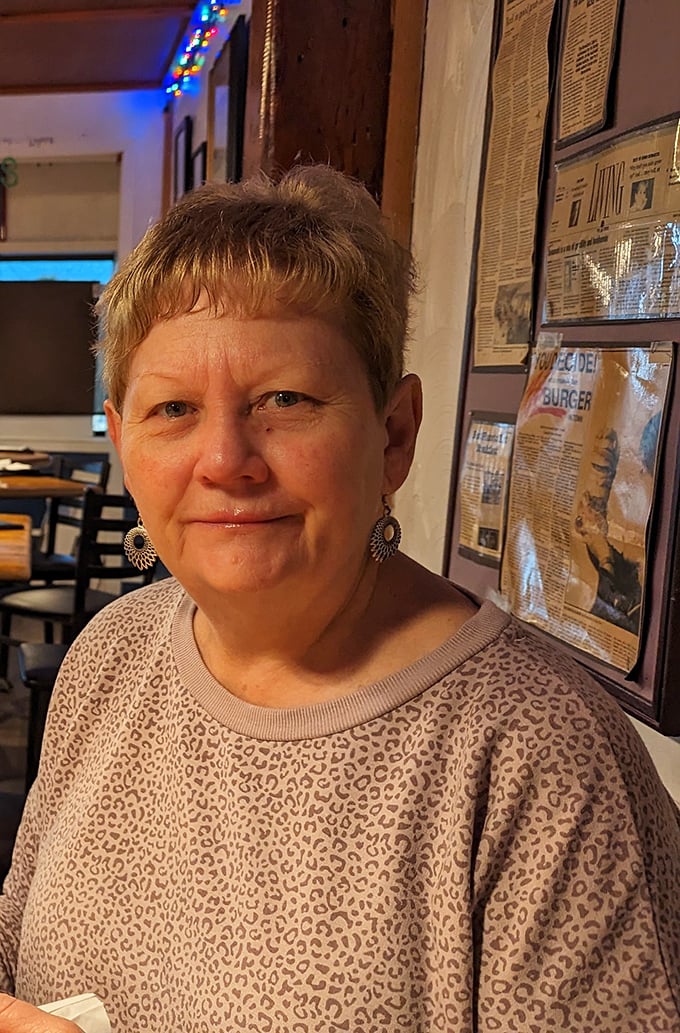 I won't identify the person in this image, but the restaurant's walls tell stories through newspaper clippings and memorabilia—a history lesson served alongside breakfast. 