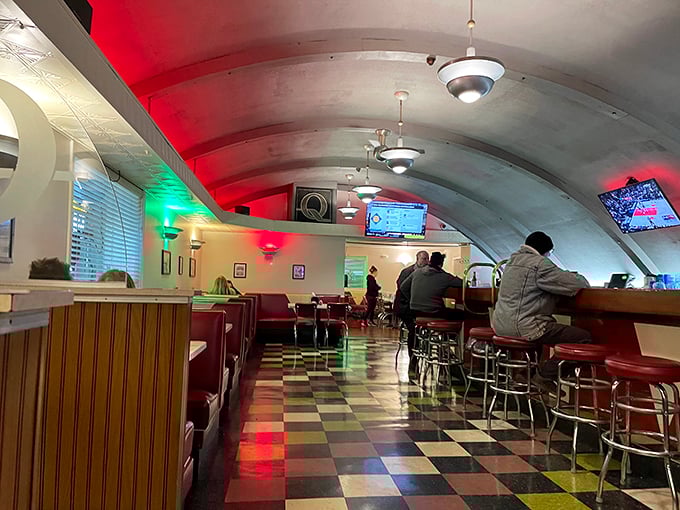 The curved ceiling creates a cocoon of comfort where food, friends, and conversation flow as freely as the drinks. Community in architectural form.