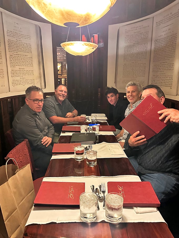 A gathering of friends enjoying the timeless pleasure of breaking bread together in surroundings that feel both special and comfortable.