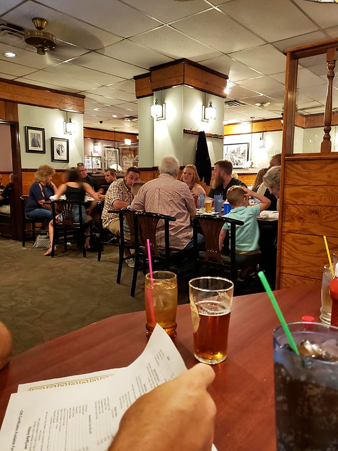 Families gather around tables where memories are made between bites of barbecue—the true measure of a neighborhood institution.