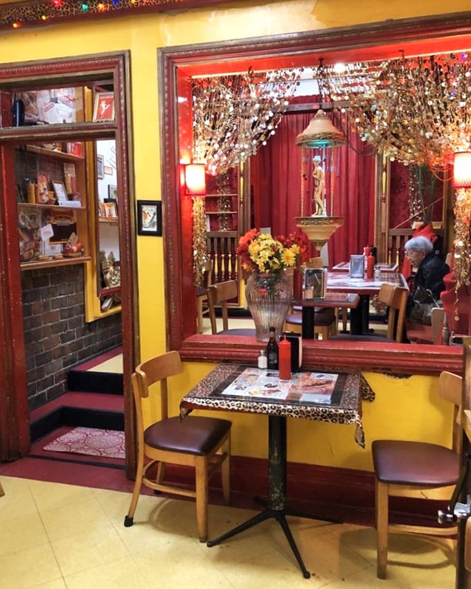 Yellow walls, red trim, and leopard print accents create a dining space that's as memorable as the food—like eating in a quirky friend's living room.