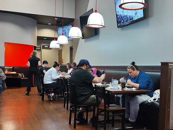 Pendant lights cast a warm glow over diners deep in conversation and deeper into their meals. The soundtrack of satisfaction plays in the background.