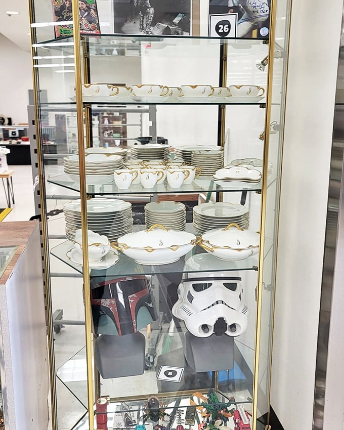 Fine china displayed in a glass cabinet alongside Star Wars collectibles – where grandma's formal dinnerware meets nerd culture in perfect harmony.