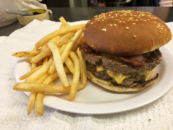 A burger that requires both hands and several napkins—the universal sign of something worth every delicious, messy bite.