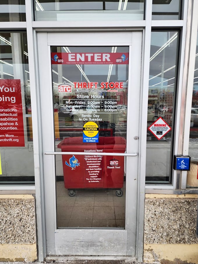 The entrance beckons with promises of treasures beyond, complete with convenient donation bin for completing the circle of thrift.