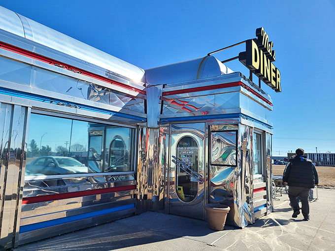 The entrance to flavor country – Mel's chrome exterior reflects both sunlight and decades of diner tradition. Step through these doors and leave your diet at home.