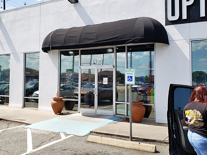 First impressions matter! The sleek storefront entrance with its welcoming awning invites fashion-forward bargain hunters into this treasure trove.