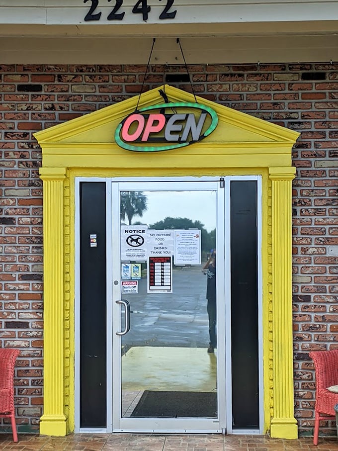 The bright yellow entrance frame and neon "OPEN" sign – like a beacon of breakfast hope in a sea of chain restaurants and green smoothie shops.