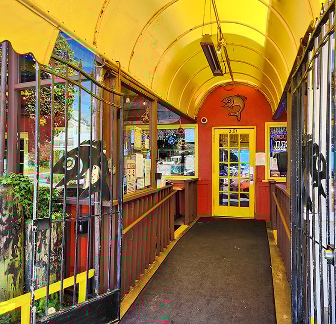 The entrance tunnel's vibrant yellow ceiling and fish motifs set the stage—you're not just entering a restaurant, you're embarking on a seafood adventure.