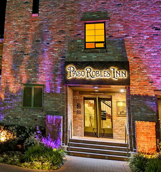 The illuminated entrance to Paso Robles Inn glows with promise as evening falls – a beacon for hungry travelers and locals alike.