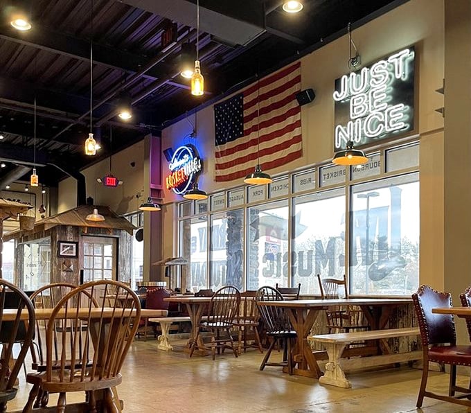 The dining area's American flag and neon signs aren't just decor—they're a backdrop for the most patriotic activity possible: devouring perfectly smoked meat.