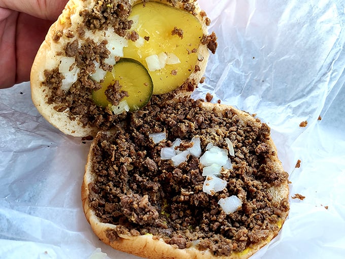 Open the sandwich to reveal the secret—perfectly seasoned meat crumbles mingling with diced onions and pickle slices.