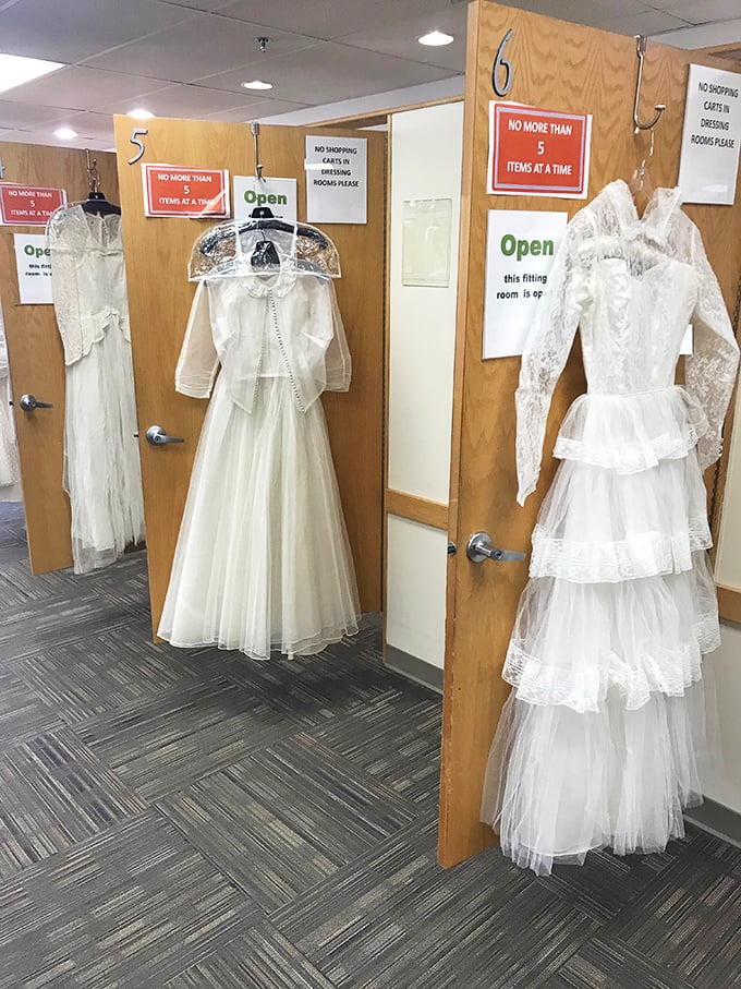 Wedding dress purgatory: where once-worn gowns wait patiently for their next trip down the aisle, tags whispering of dramatic discounts.