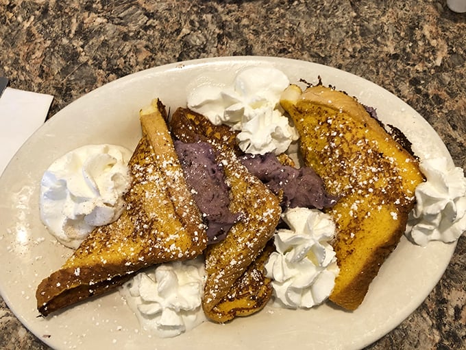 French toast that makes ordinary bread realize its full potential—golden, crisp edges giving way to custardy centers and berry bliss.