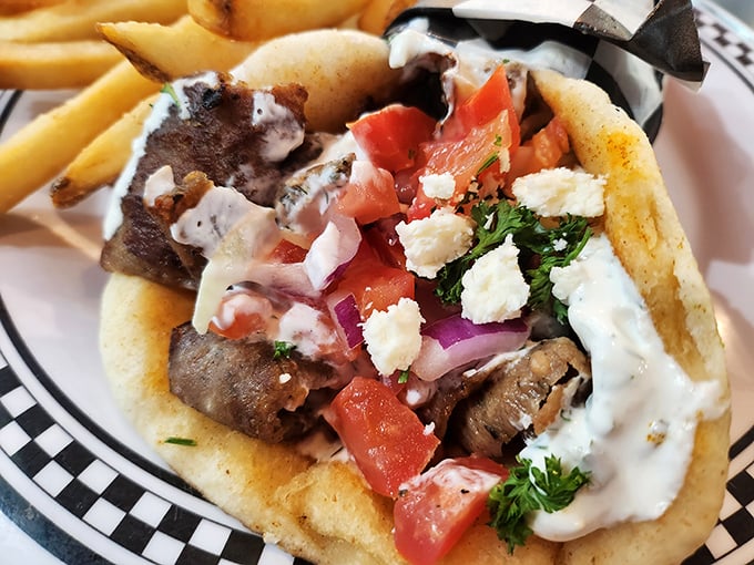 This gyro doesn't just satisfy hunger—it resolves it completely. Tzatziki cascading over perfectly seasoned meat in a handheld flavor festival.