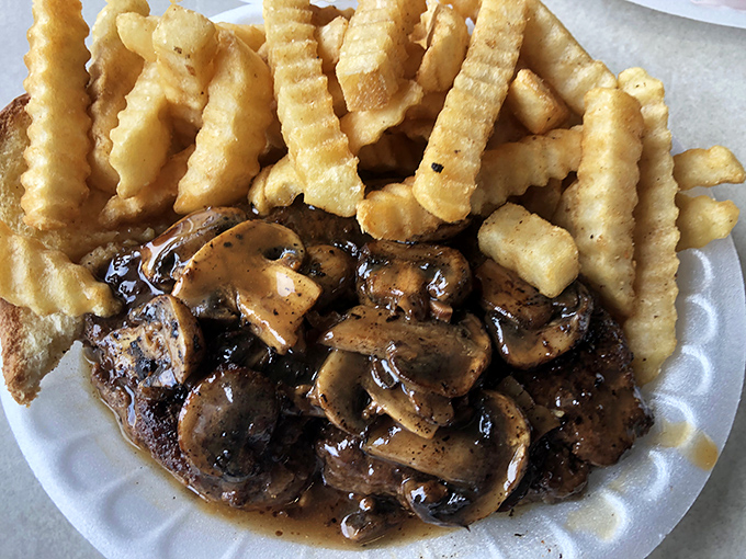 The hamburger steak with mushroom gravy and crinkle-cut fries—comfort food that whispers, "Everything's going to be alright."