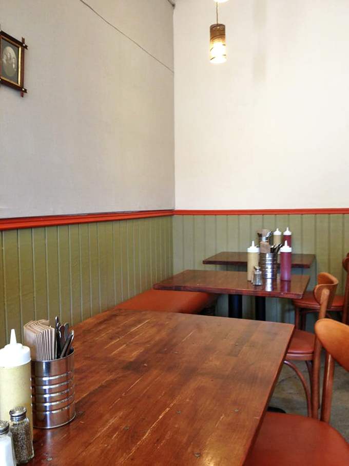 Simple wooden tables and chairs invite conversation and lingering. No pretension here—just good food and the warm glow of community.