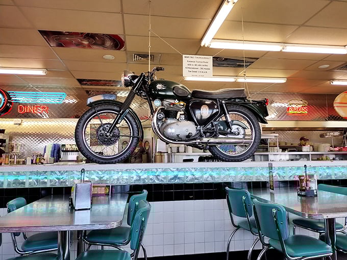 That's not just a motorcycle—it's dining room decor with a side of rebellion. The turquoise chairs below wait patiently for diners who appreciate both horsepower and pancake power.