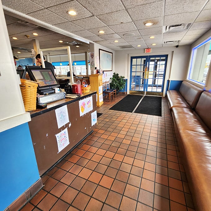 The entrance – where the "Hostess Will Seat You" sign is both instruction and promise of hospitality.
