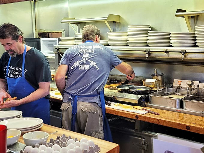 That kitchen crew working the griddle with stacks of plates ready—efficiency and quality happening simultaneously, like a delicious ballet.