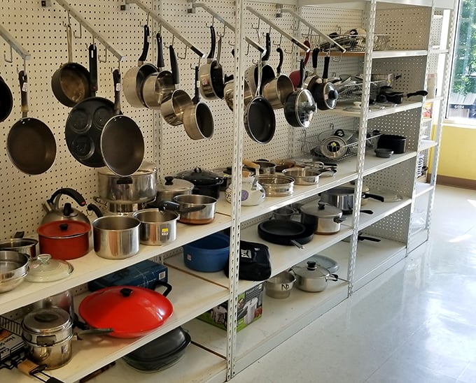 The kitchenware section hangs with possibility—cast iron treasures and stainless workhorses waiting to help create your next culinary masterpiece at bargain prices.